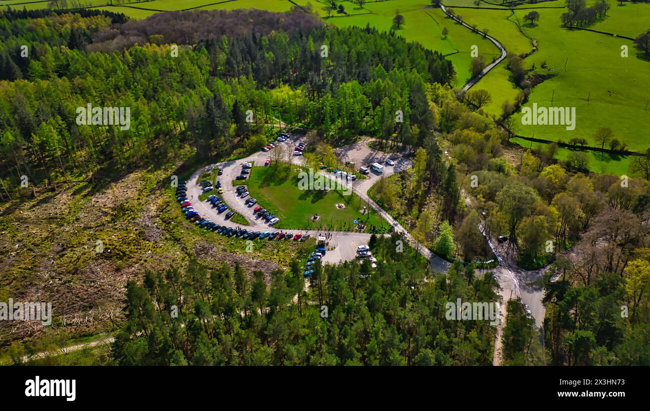 Aerial view of a parking lot surrounded by lush greenery and a winding ...