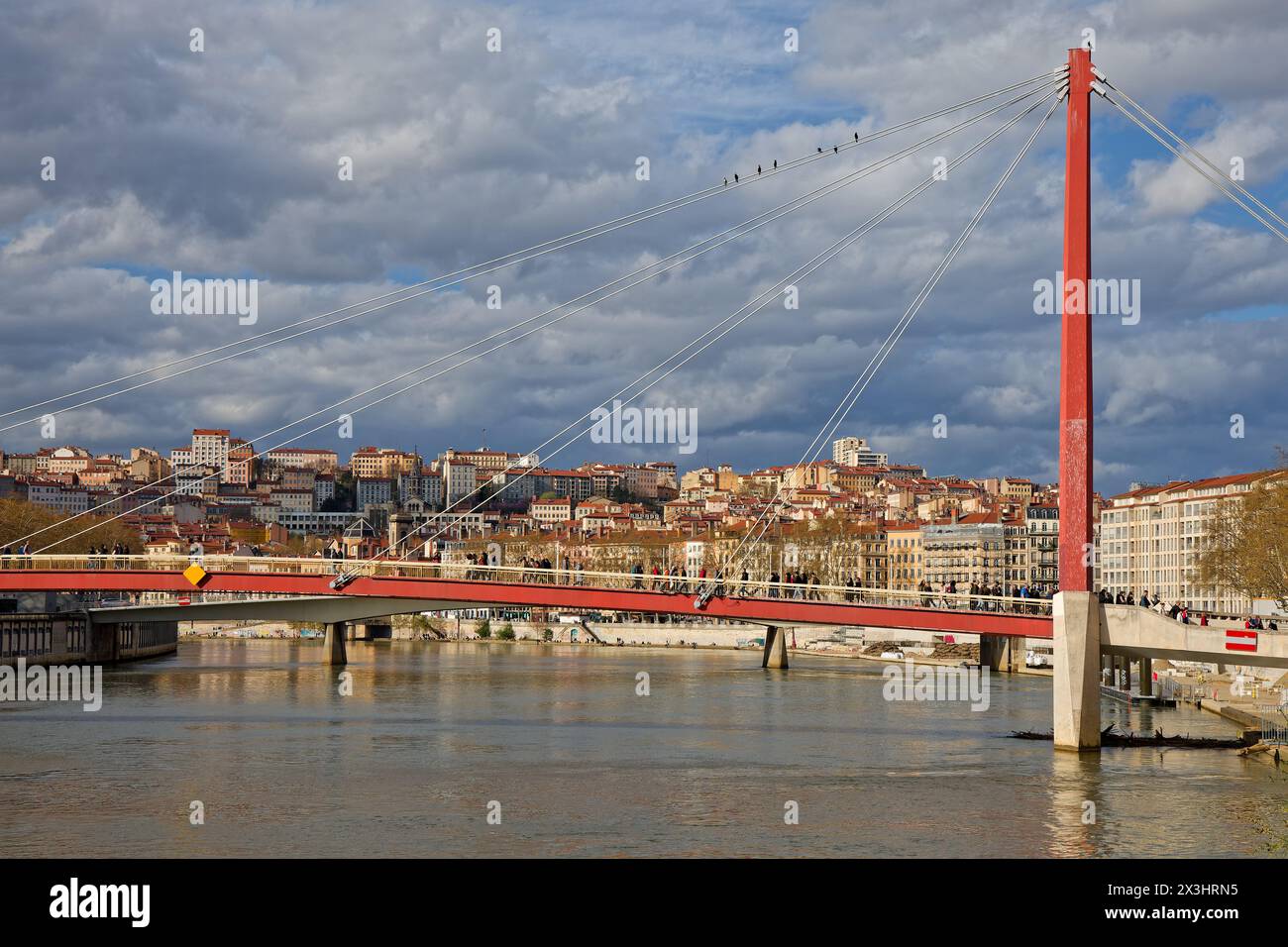 Saone river and pedestrian bridge in lyon, with Croix-Rousse hill in ...