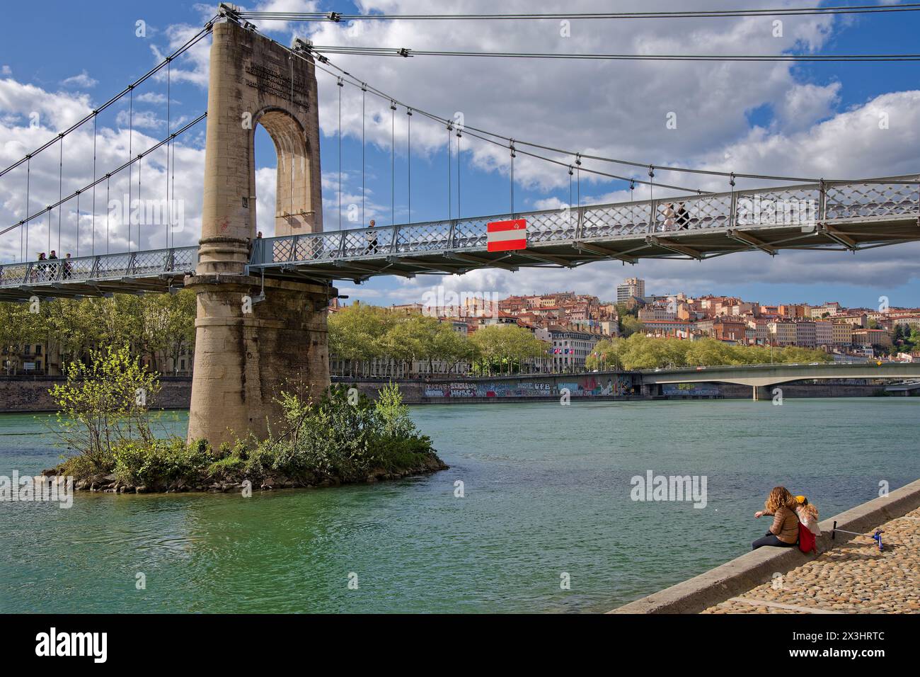 LYON, FRANCE, April 10, 2024 : Pedestrian bridge over Rhone. Lyon takes ...