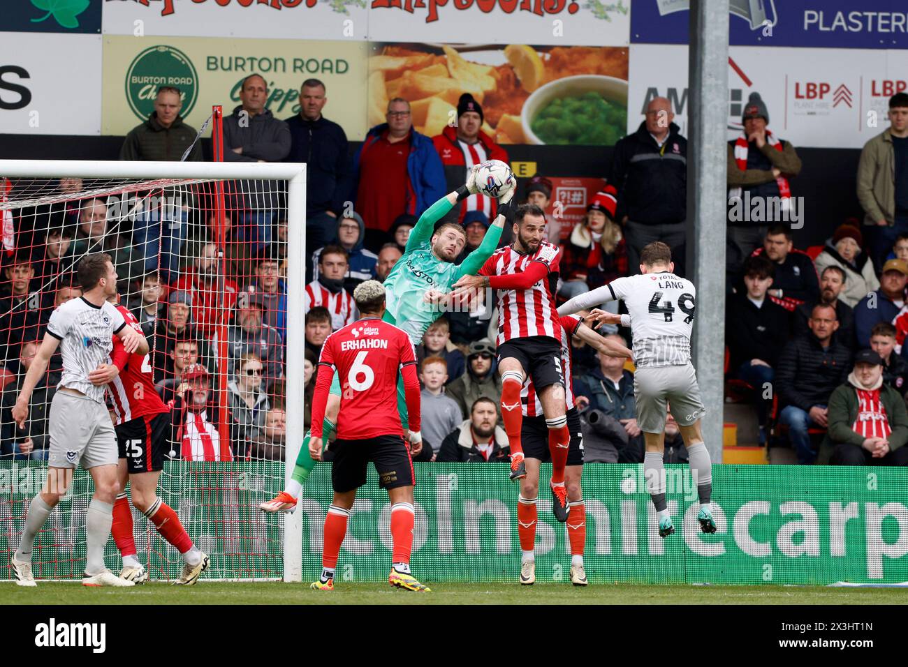 Lincoln City goalkeeper Lukas Jensen and Lincoln City's Adam Jackson in ...