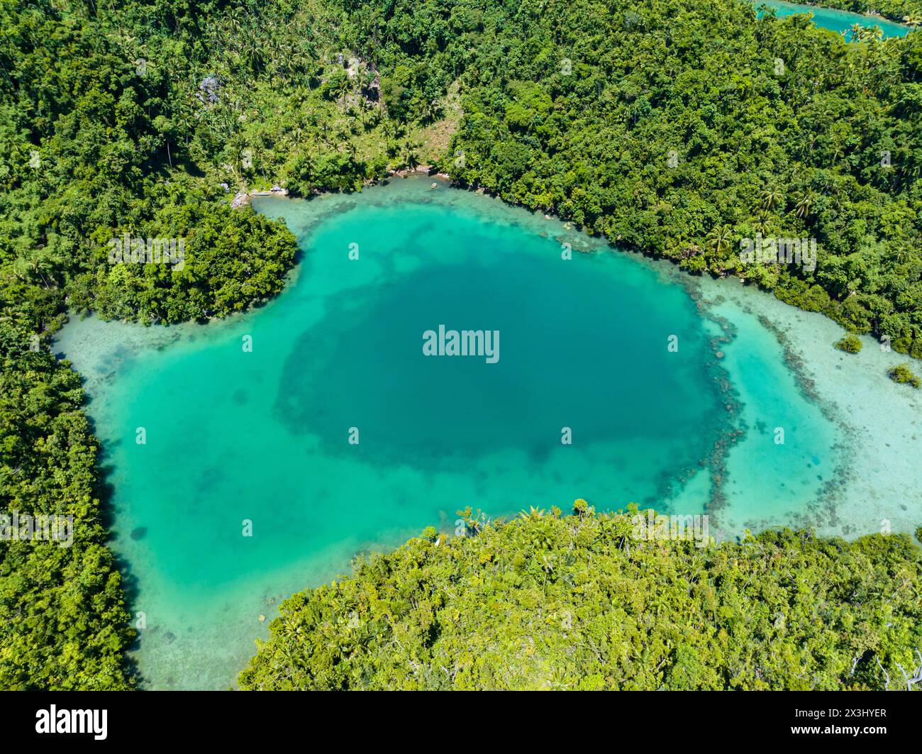 Turquoise water in lagoon with coral reefs in Tinago Island. Mindanao ...