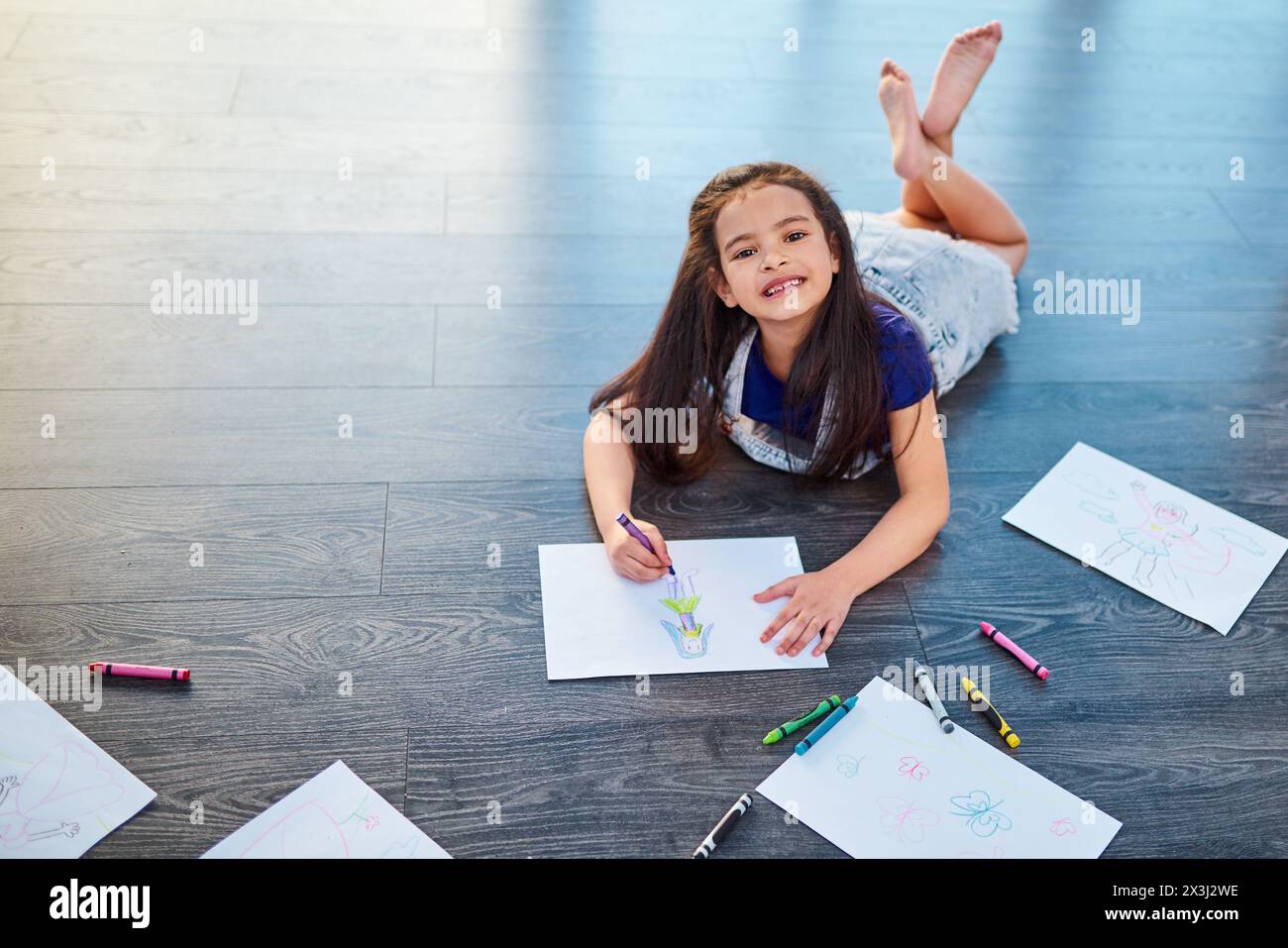 Female child, sketch and drawing on floor in house with color pencil ...