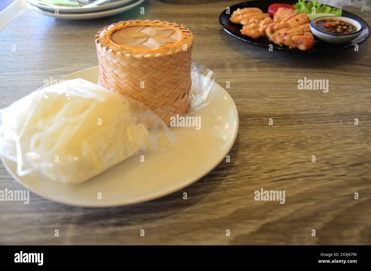 Thai food sticky rice in bamboo container with baked grilled and ...