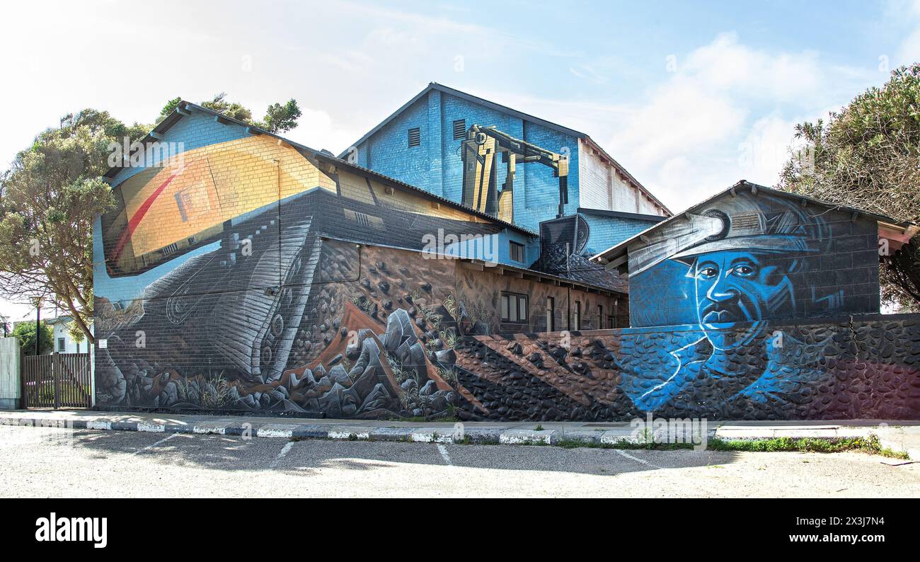 A huge mural depicting different aspects of mining, covering a building ...