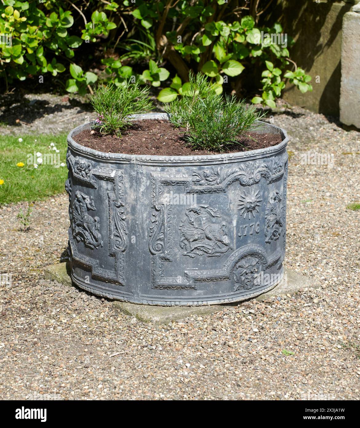 Ornate vintage lead garden planter with decorative motifs and small ...