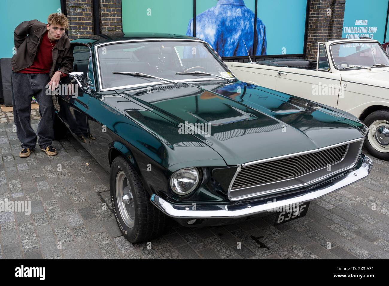 London, UK. 27 April 2024. Frankie Wilson 18, with a Ford Mustang GT ...