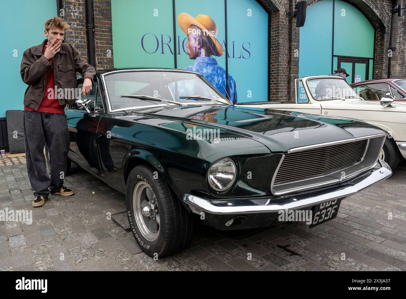 London, UK. 27 April 2024. Frankie Wilson 18, with a Ford Mustang GT ...