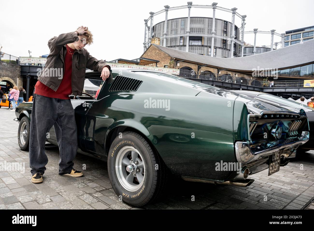 London, UK. 27 April 2024. Frankie Wilson 18, with a Ford Mustang GT ...