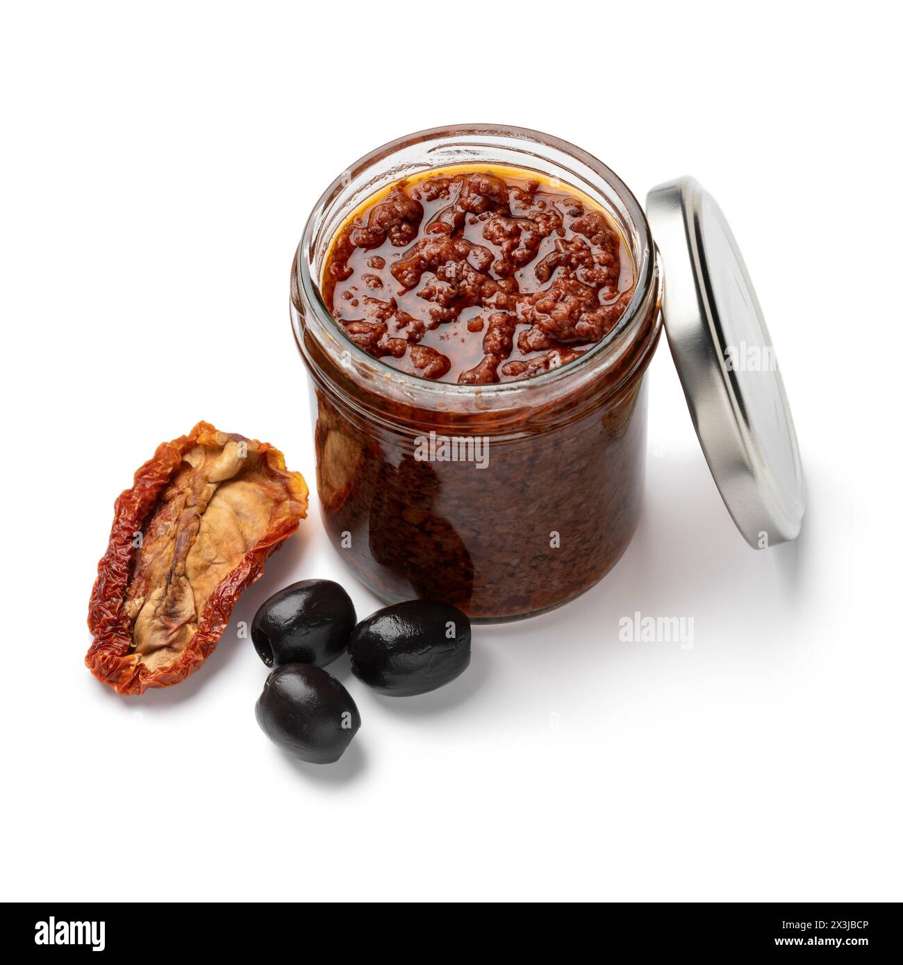 Glass jar with traditional homemade black olive tapenade close up ...