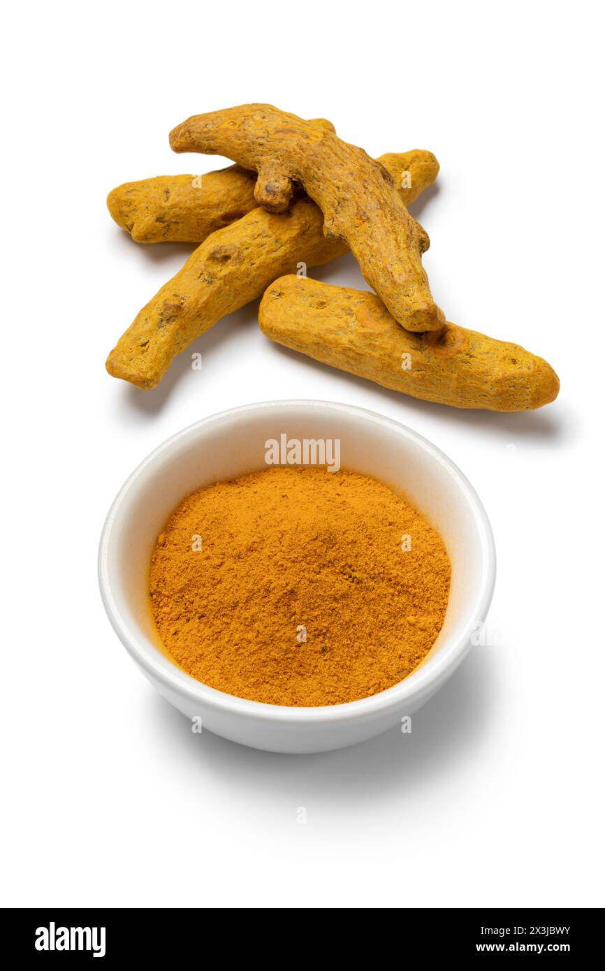 Dried Curcuma and a bowl with curcuma powder isolated on white ...