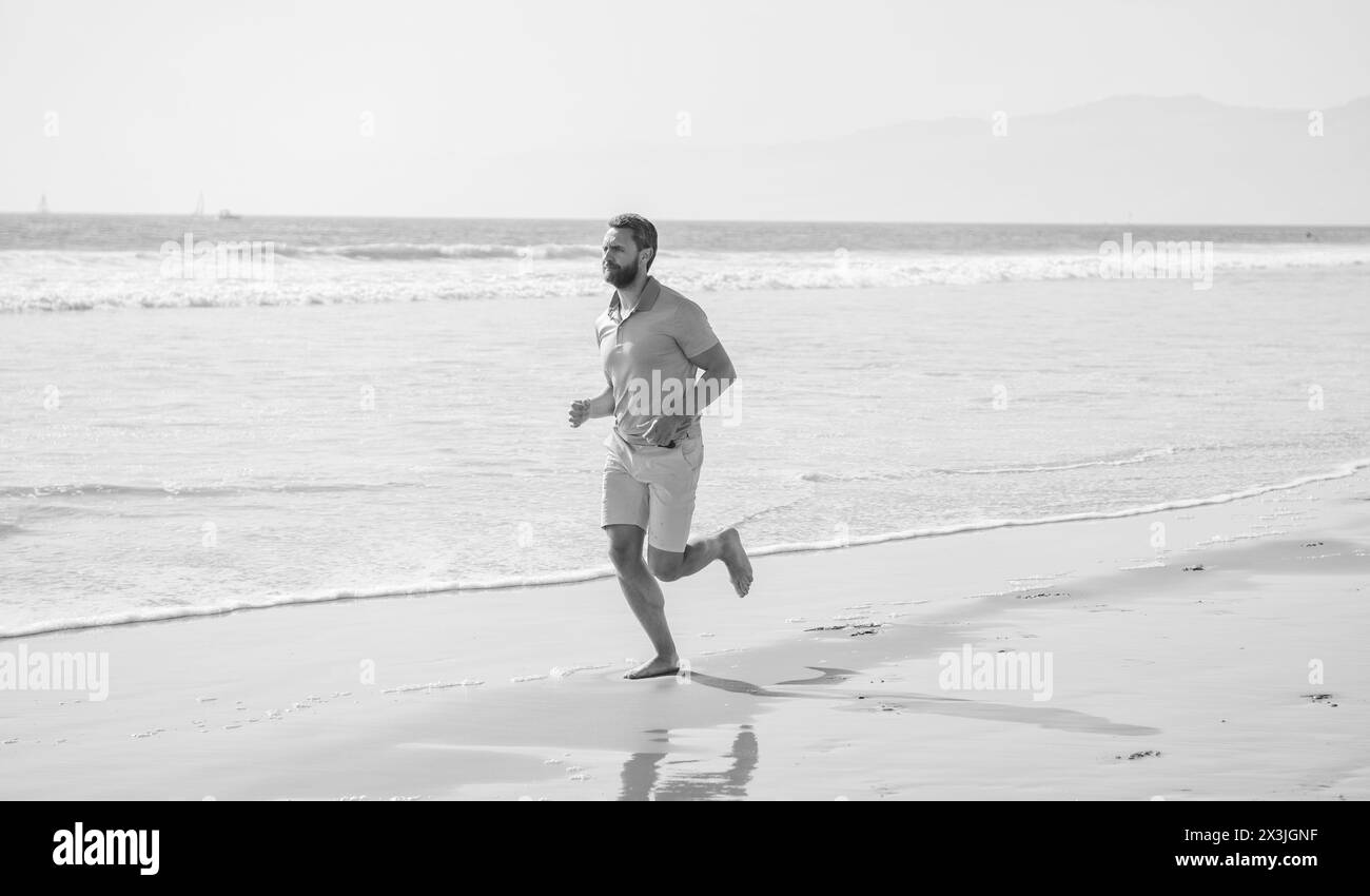 happy man runner running barefoot on summer beach, activity Stock Photo ...