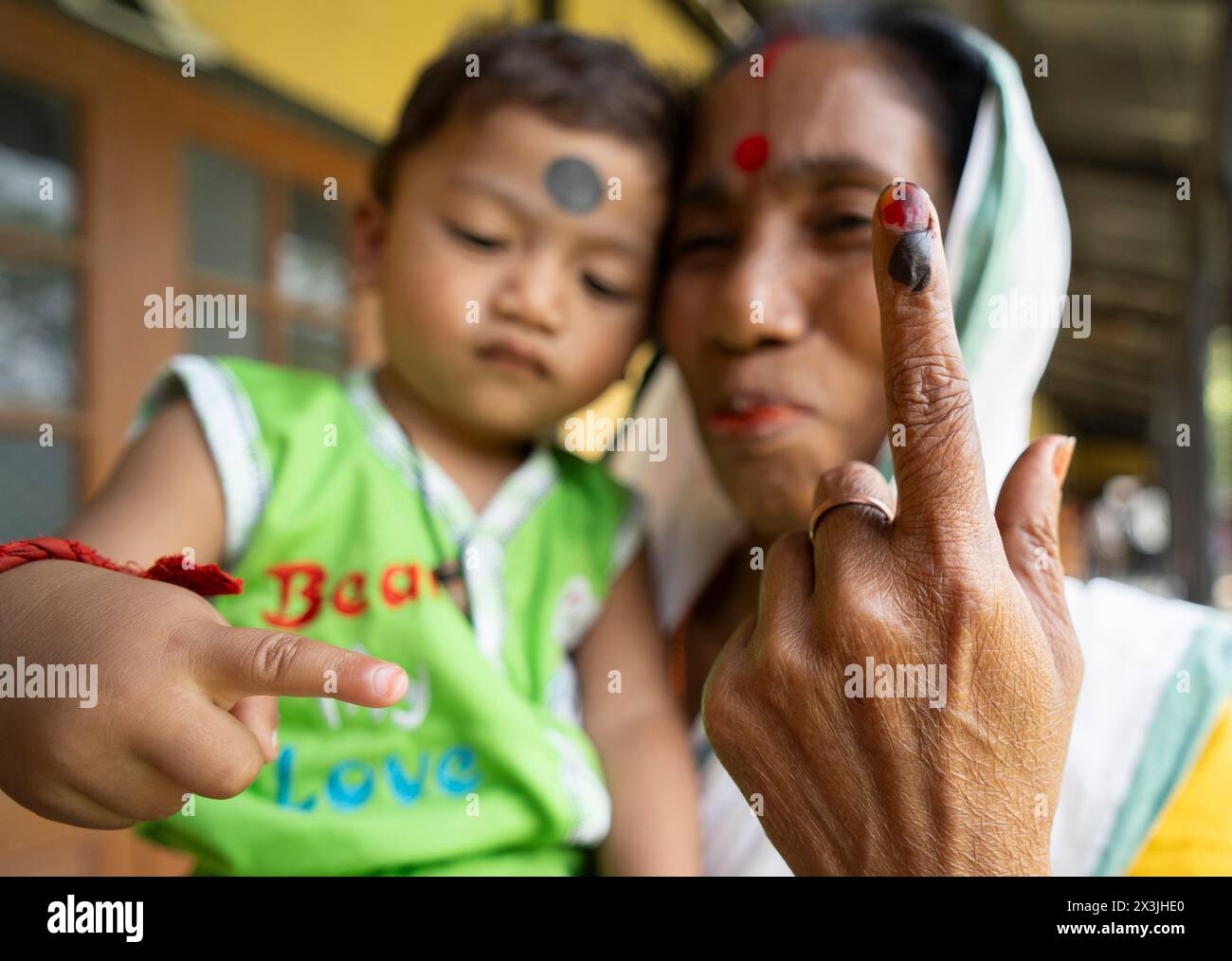 Morigaon, Assam, India. 26th Apr 2024. A woman shows her inked finger ...