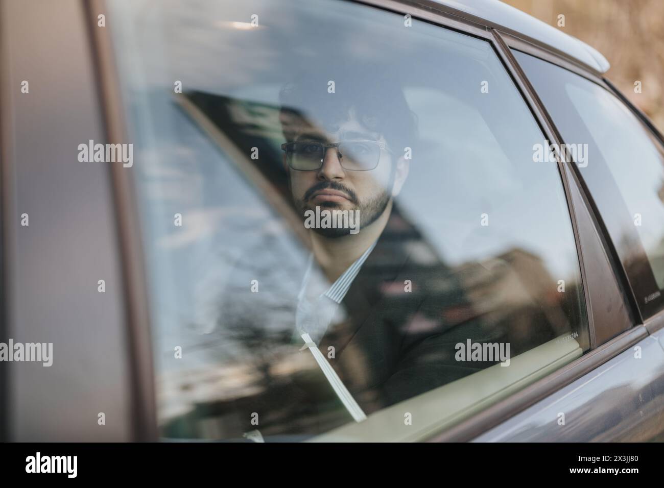 Person sitting inside a car, view through the side window Stock Photo ...