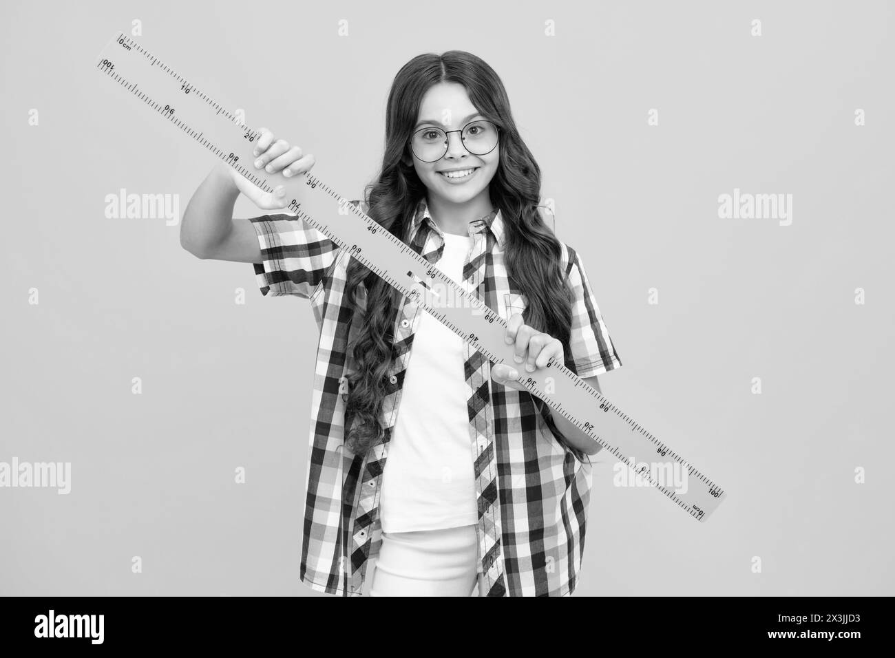 Measuring school equipment. Schoolgirl holding measure for geometry ...