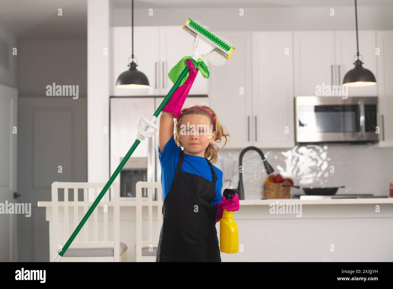Housekeeping, home chores. Portrait of child helping with housework ...