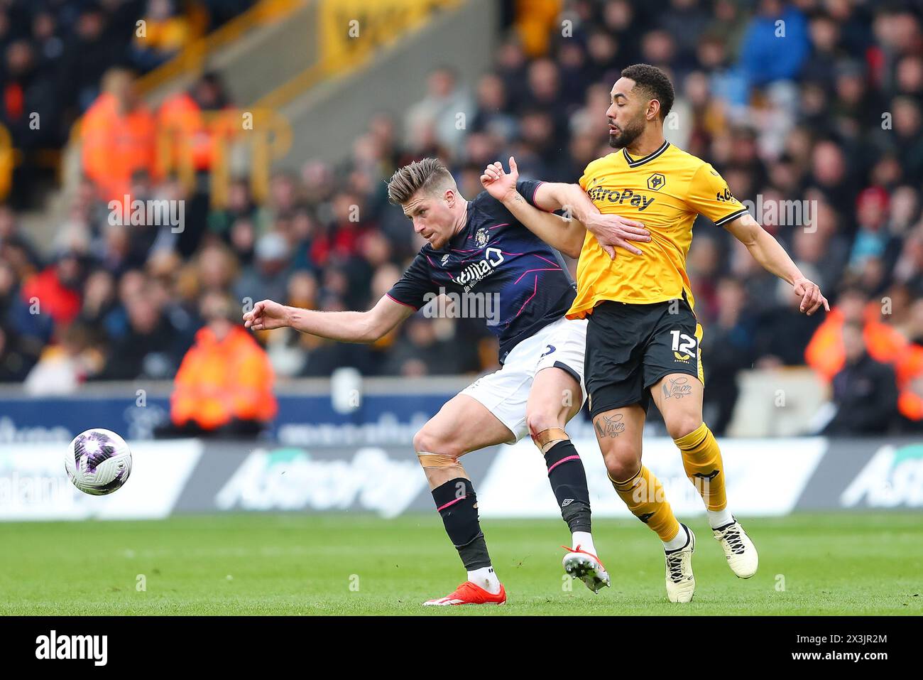 Reece Burke of Luton Town and Matheus Cunha of Wolves in action during ...