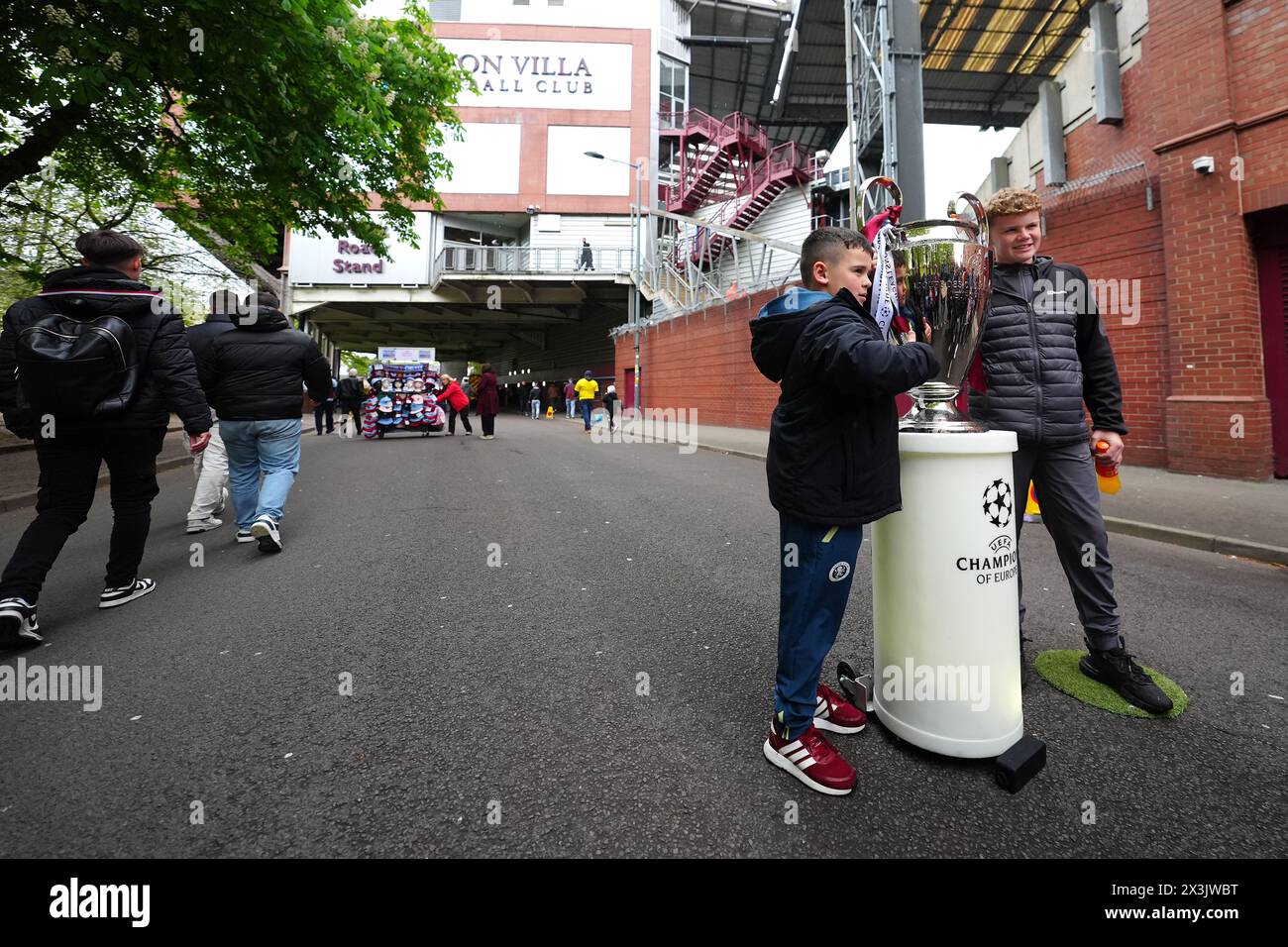 Fans pose with a replica of the UEFA Champions League trophy outside ...