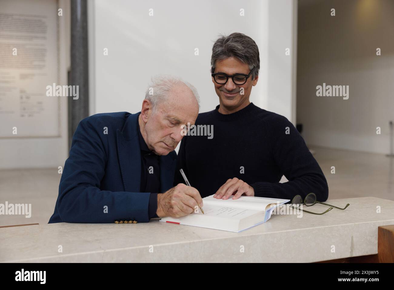 Portrait of Ali Kazma (artist) with Massimo Minini dedicating Orhan ...