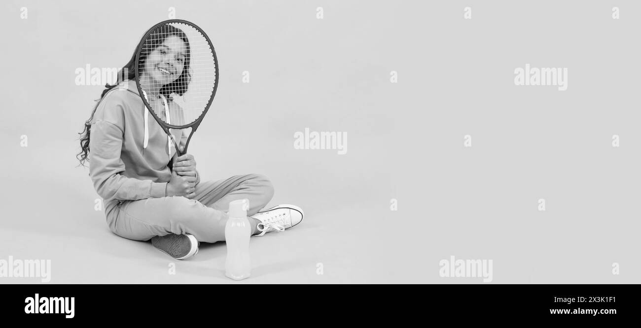 happy child sit in sportswear with squash racket and water bottle on ...