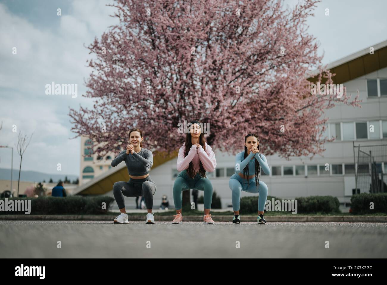 Woman performing squats outdoors hi-res stock photography and images ...