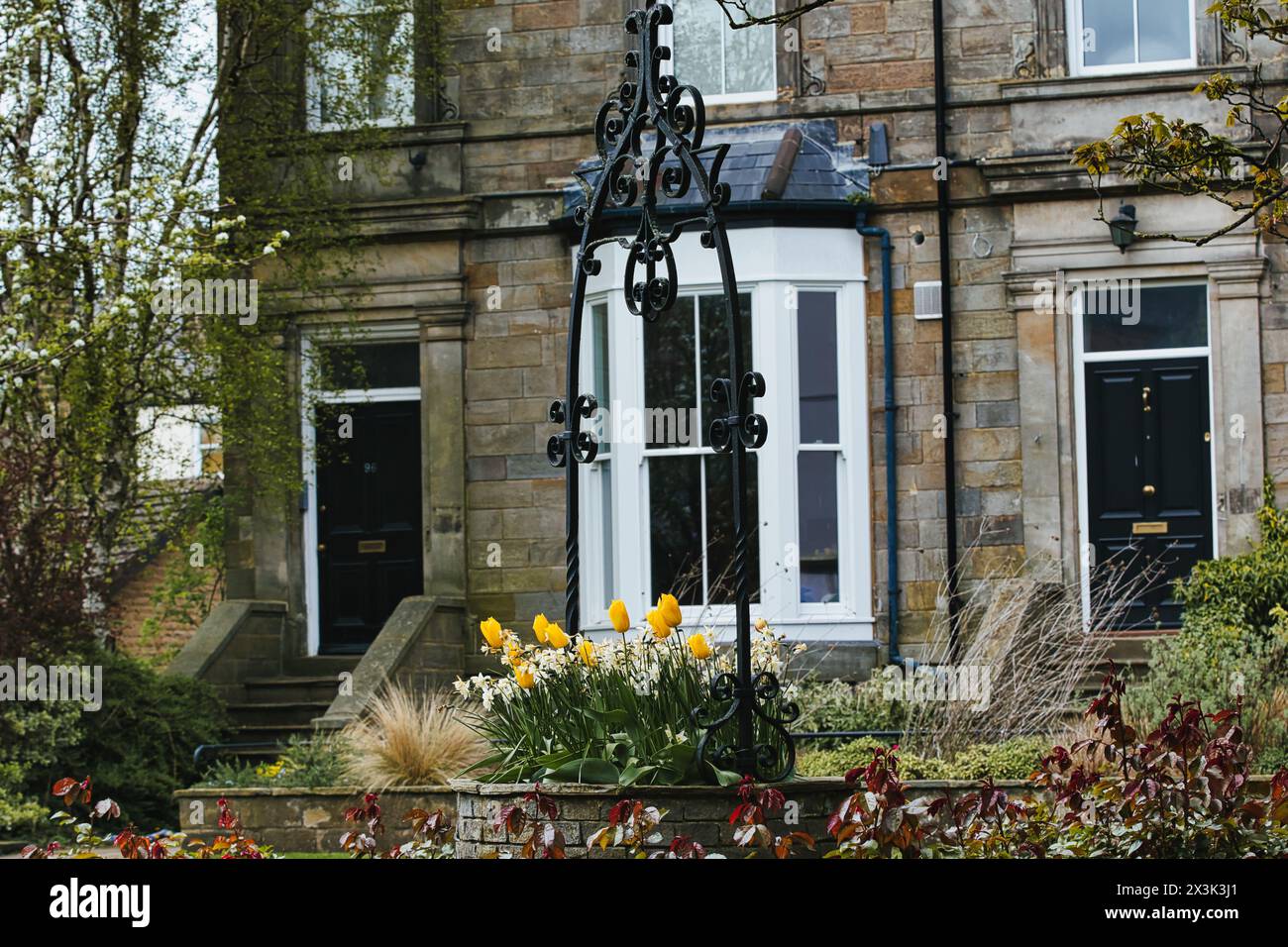 A charming old house with a decorative iron lamp post in the foreground ...