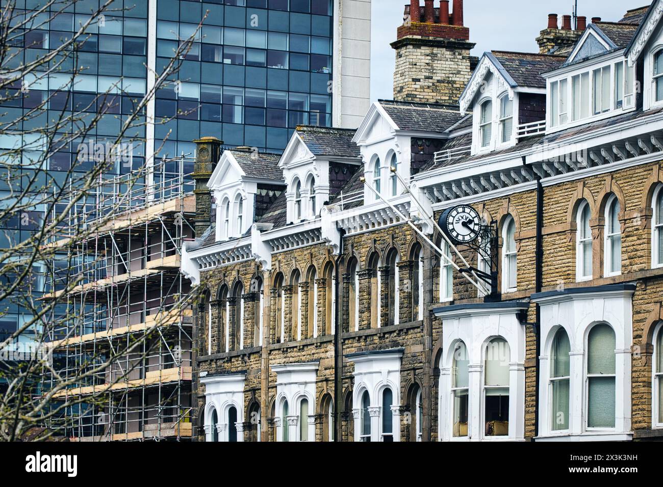 Traditional Victorian houses with ornate facades in front of modern ...