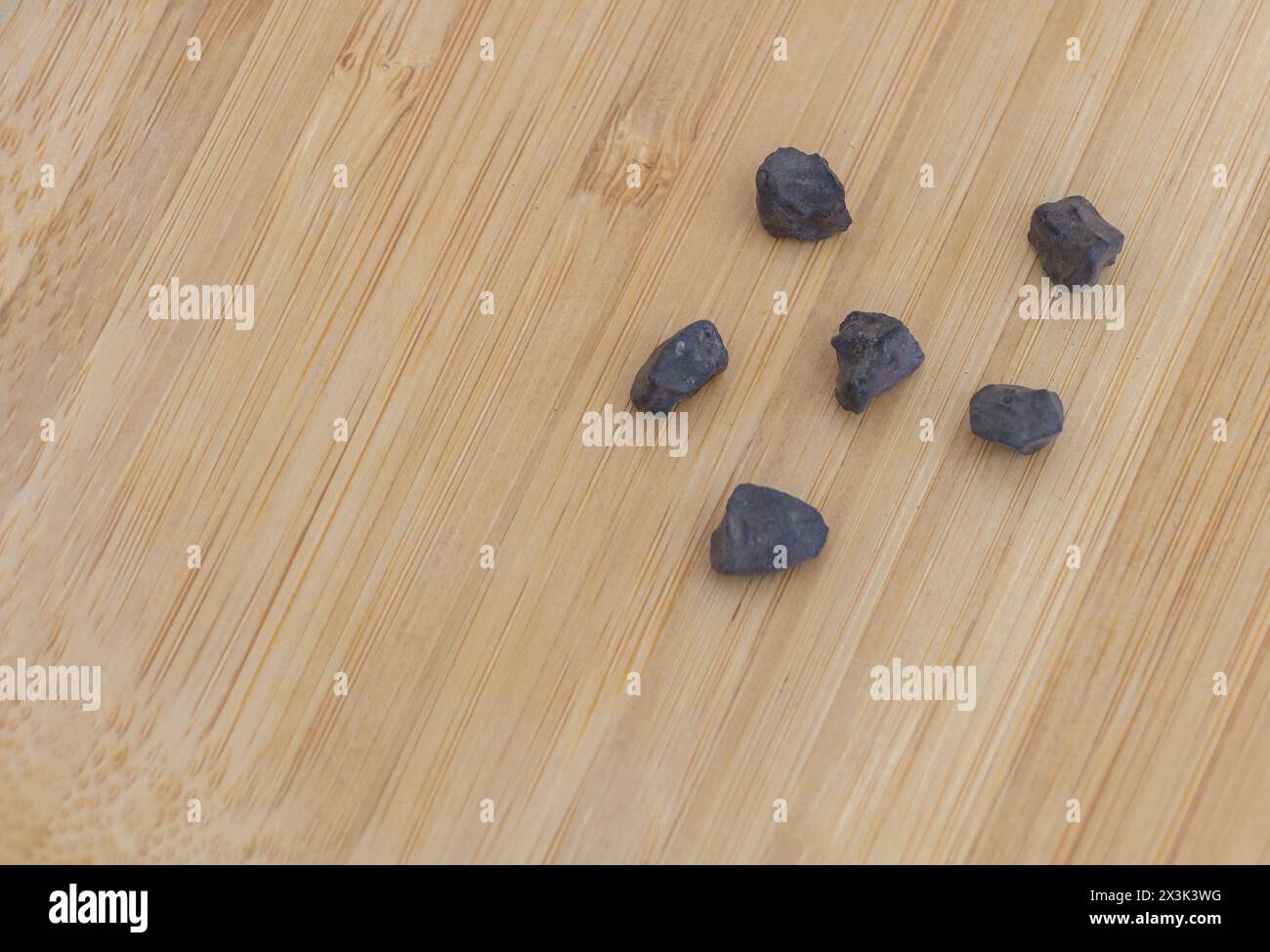 A few banana seeds of Mua sikkimensis on wooden background close up ...