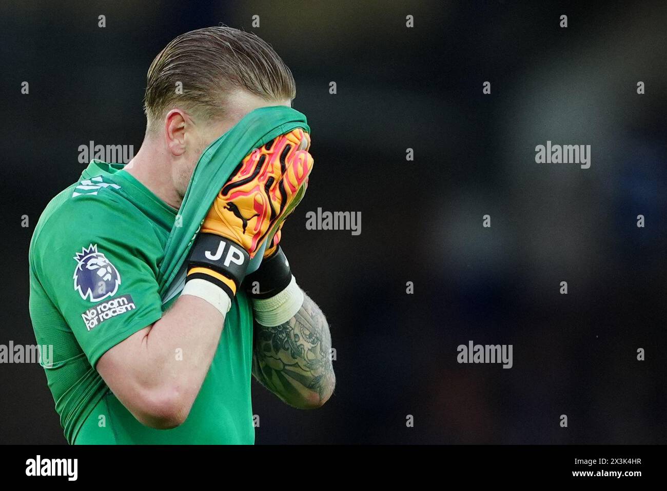 Everton goalkeeper Jordan Pickford wipes his face with his shirt during ...