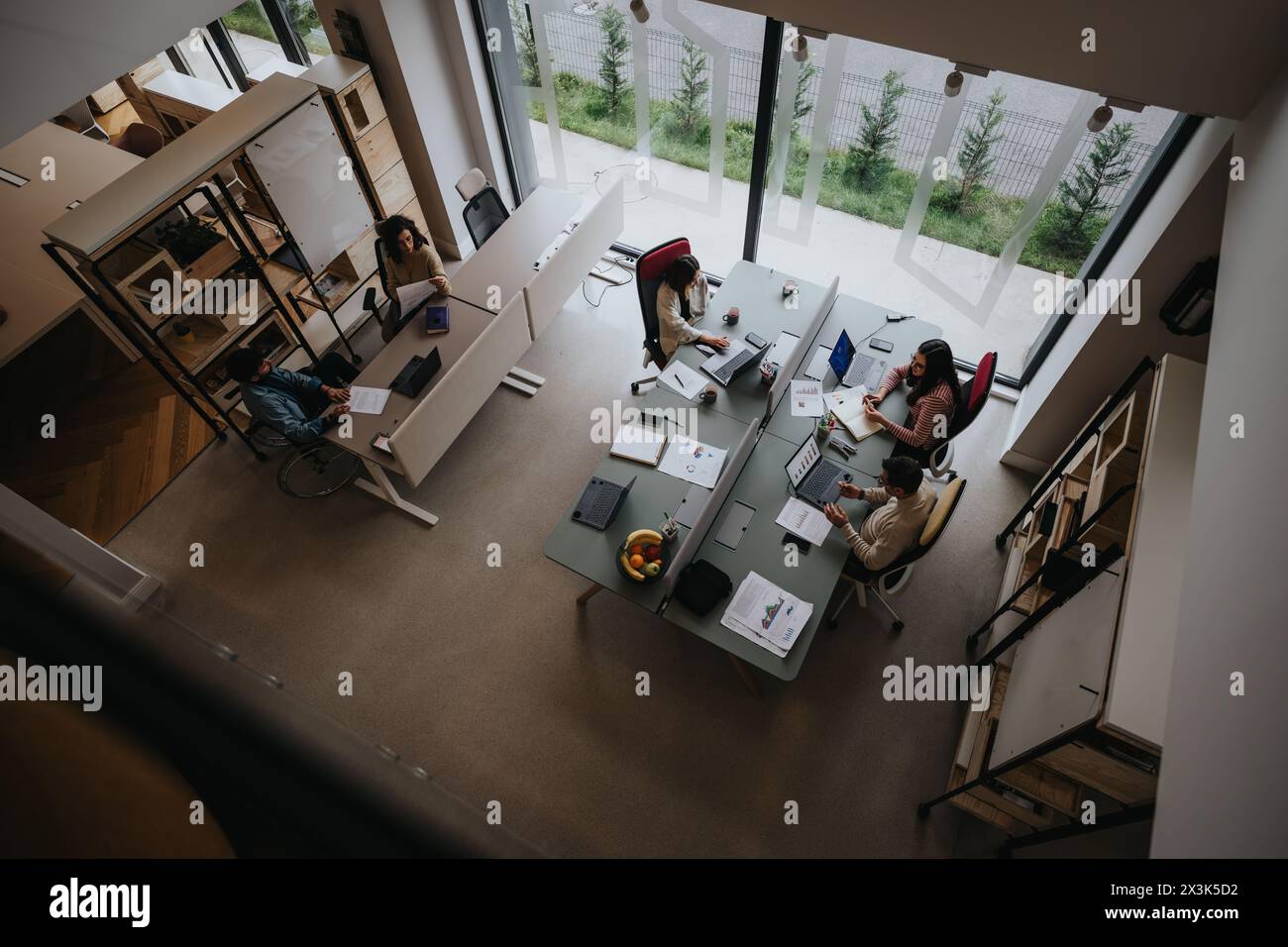 Modern office space with multiethnic team collaborating at desks ...