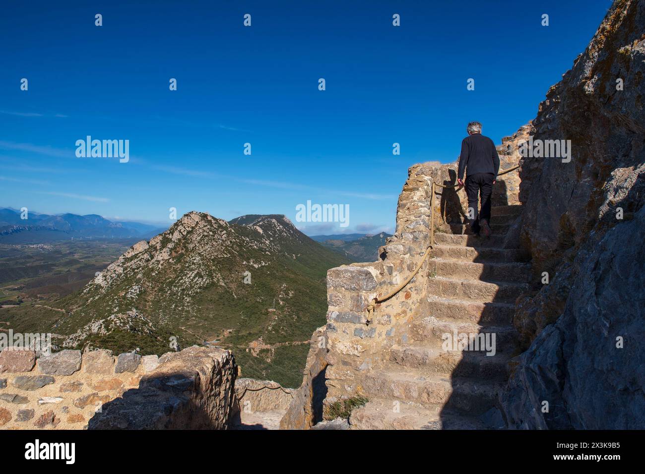 Tourist in the ruins of the medieval castle of Quéribus, in the Cathar ...