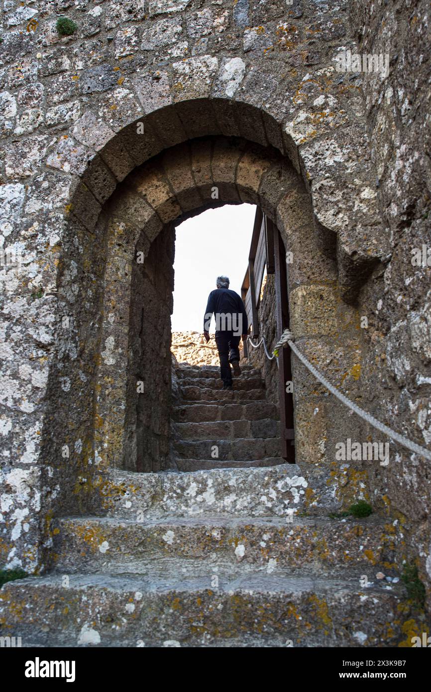 Tourist in the ruins of the medieval castle of Quéribus, in the Cathar ...