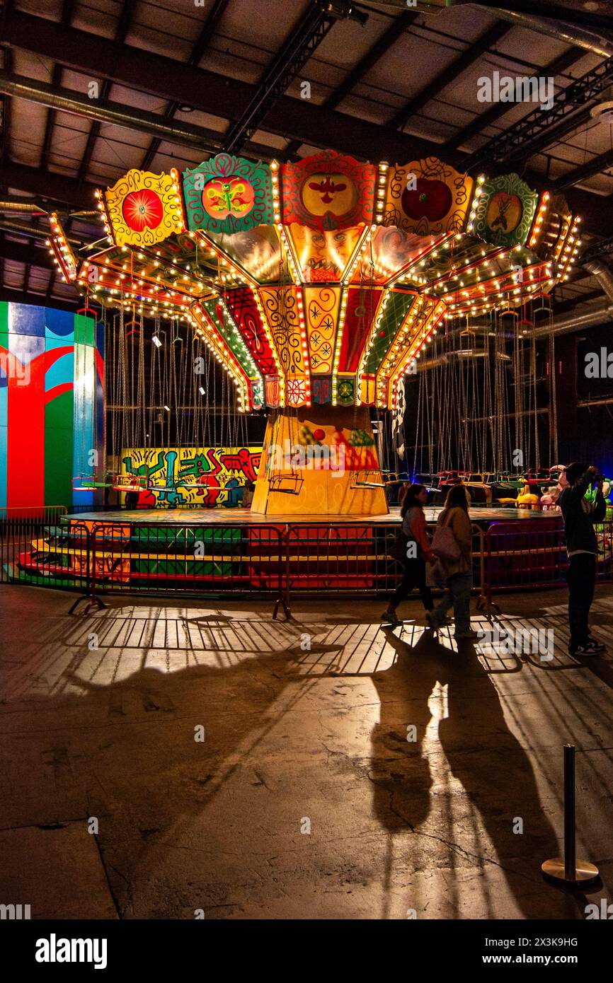 The Luna Luna art amusement park includes a painted swing chair ride by ...