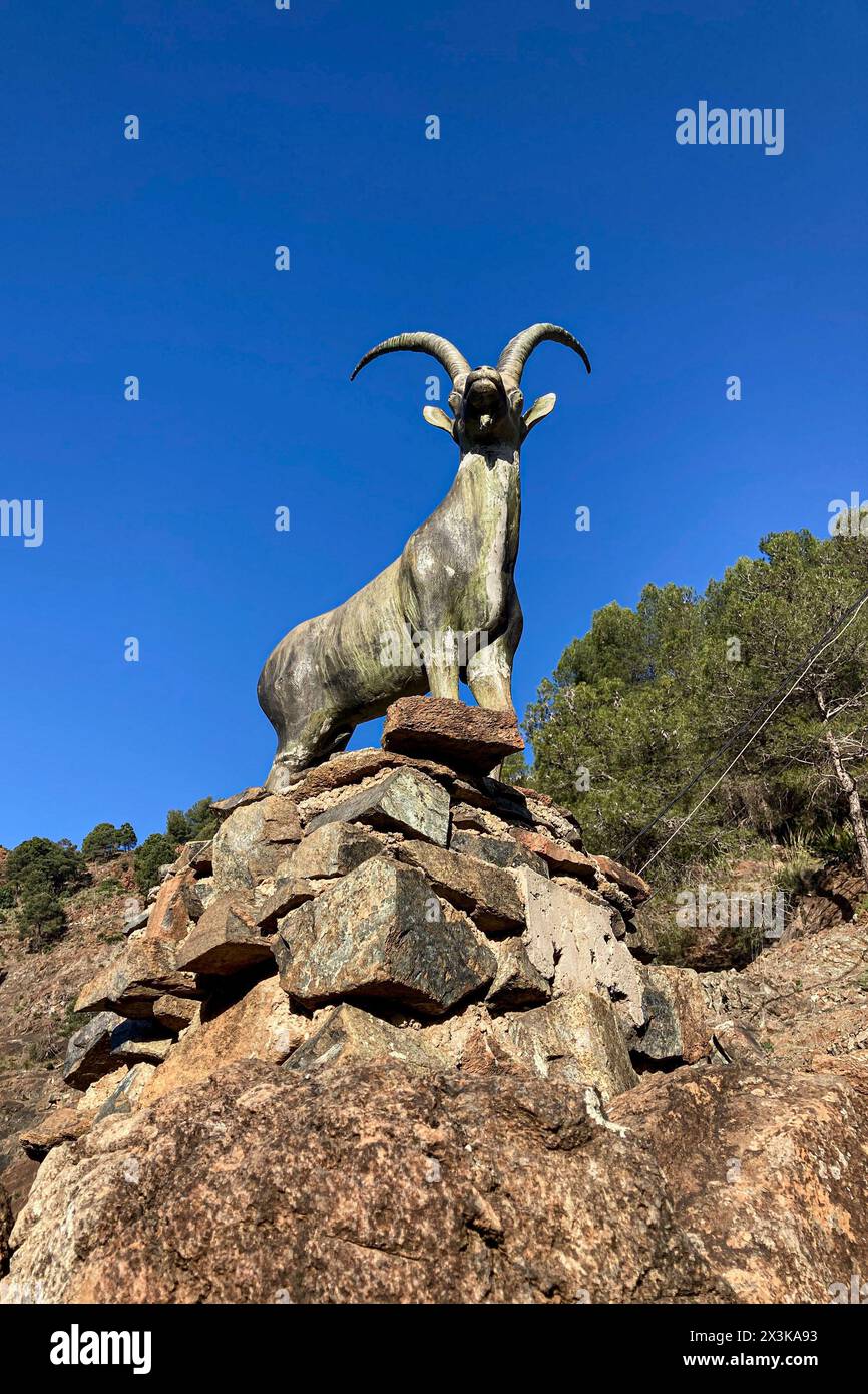 TOLOX, SPAIN - APRIL 13, 2024: Goat statue on start of the hiking trail ...