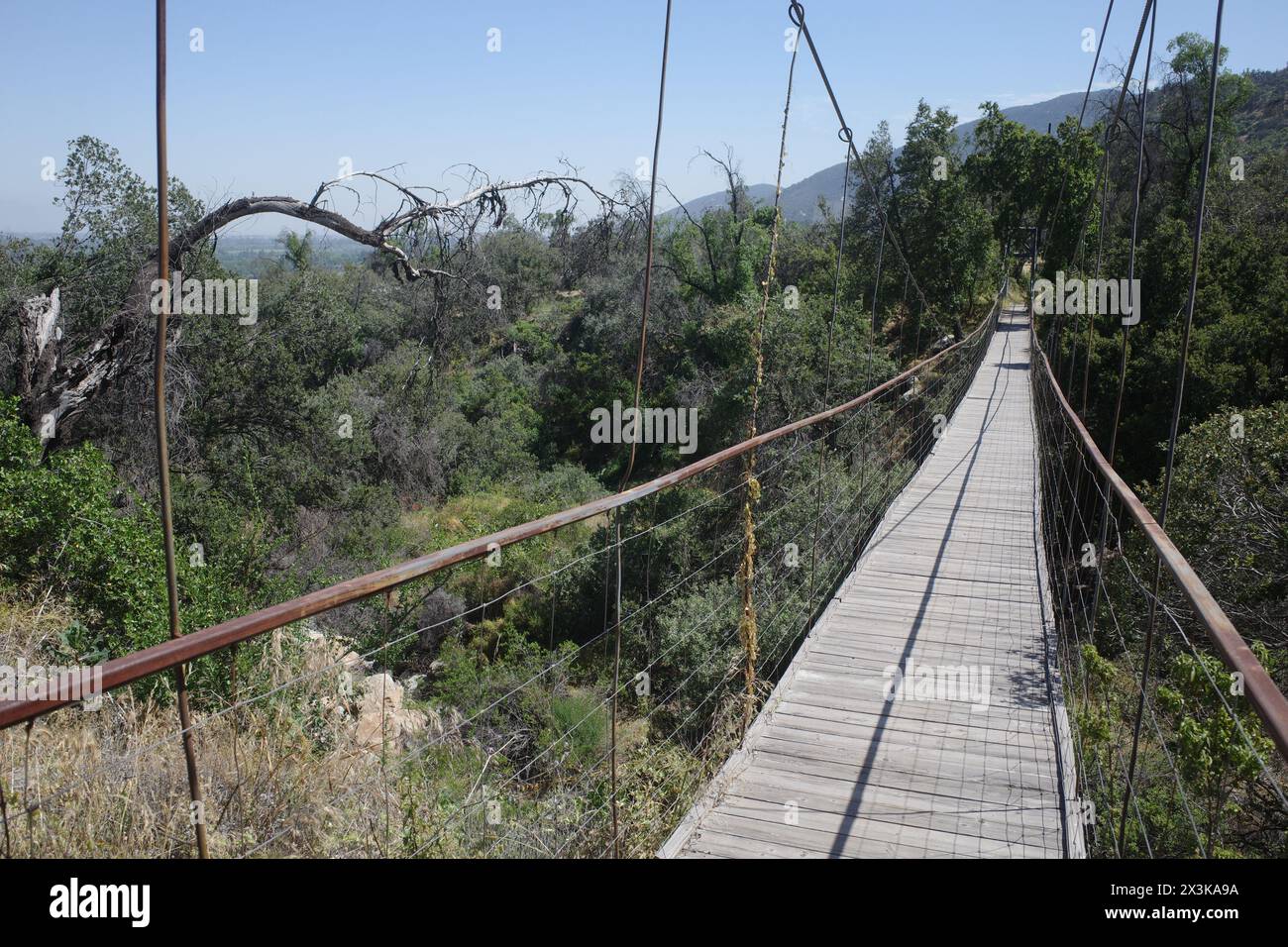 Pirque, Chile - 25 Nov, 2024: A suspension footbridge across a stream ...