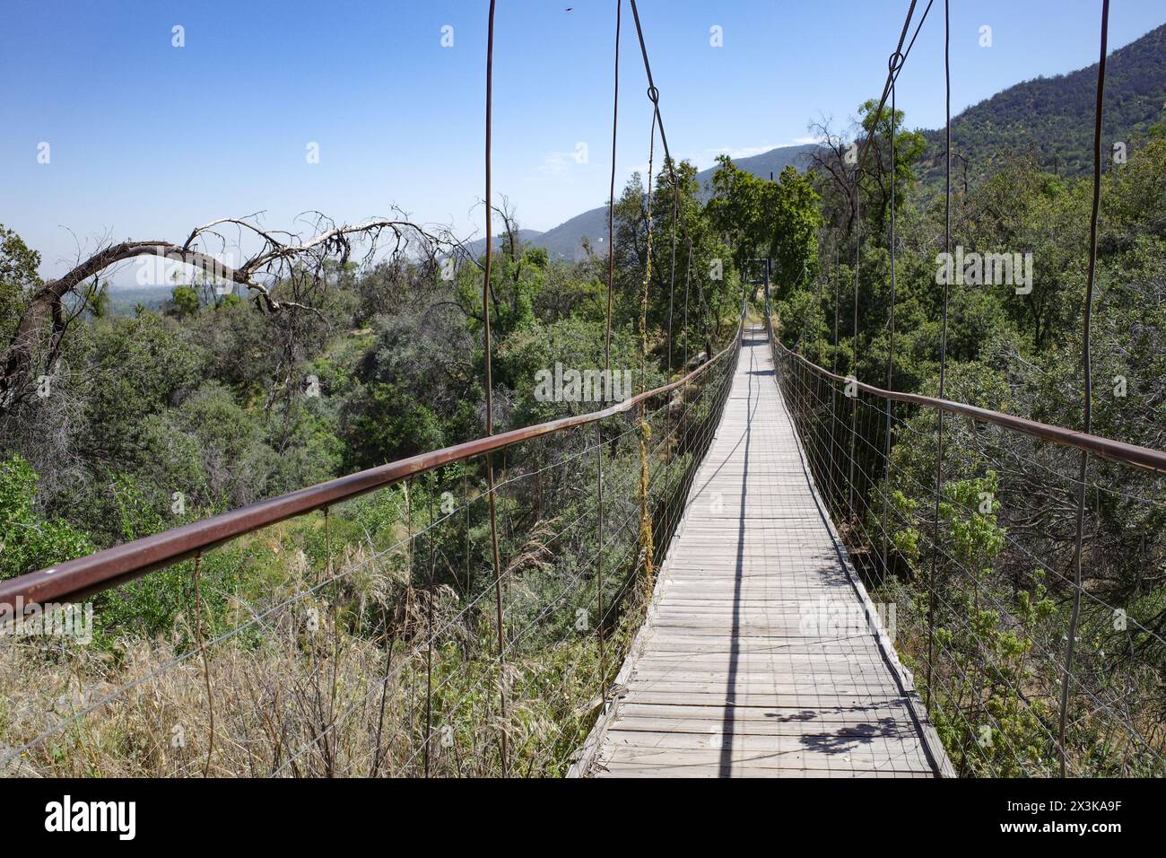 Pirque, Chile - 25 Nov, 2024: A suspension footbridge across a stream ...