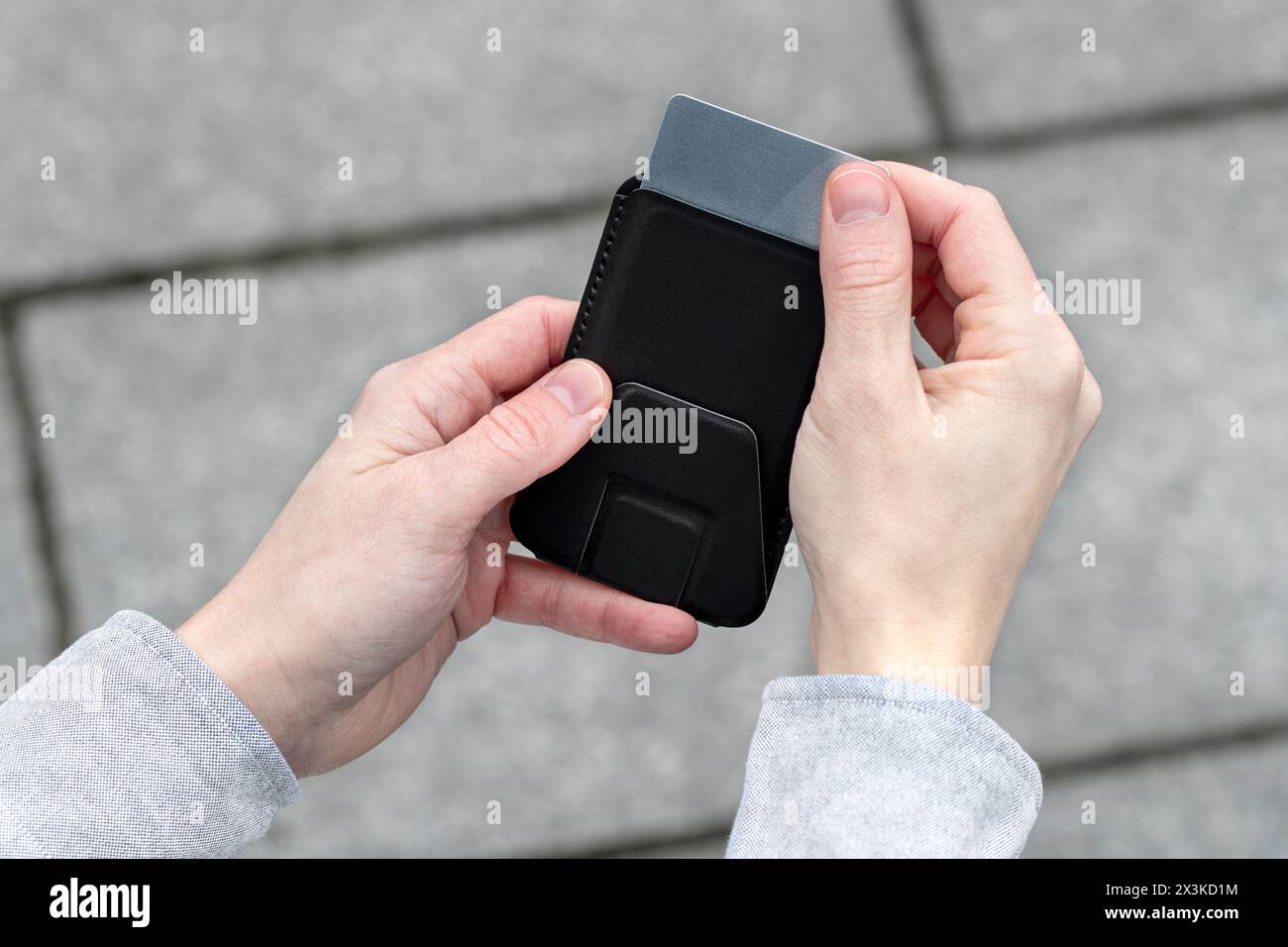 Woman pulling out credit card outside in city, wearing shirt Stock ...