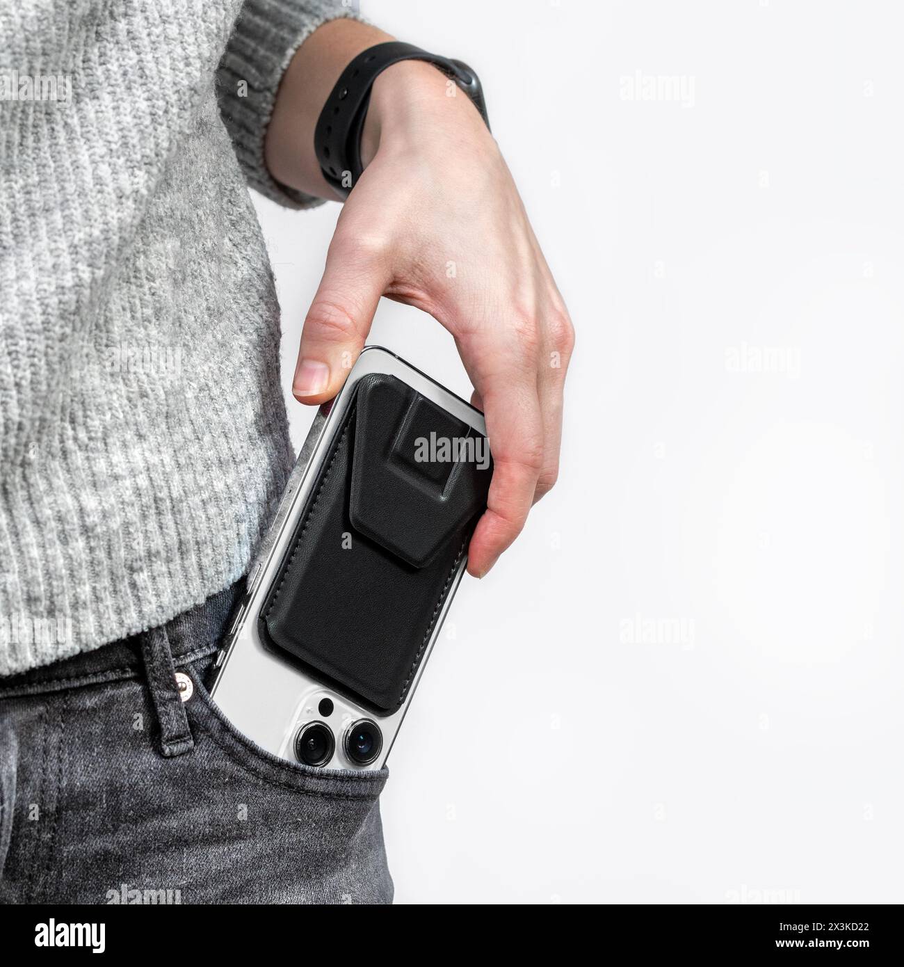 Woman taking out her phone from pocket on white background Stock Photo ...
