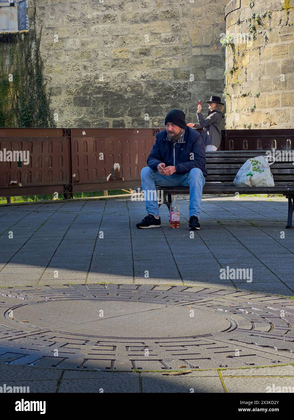 Bordeaux, France — March 13, 2024. A wide-angle photo of a man sitting ...
