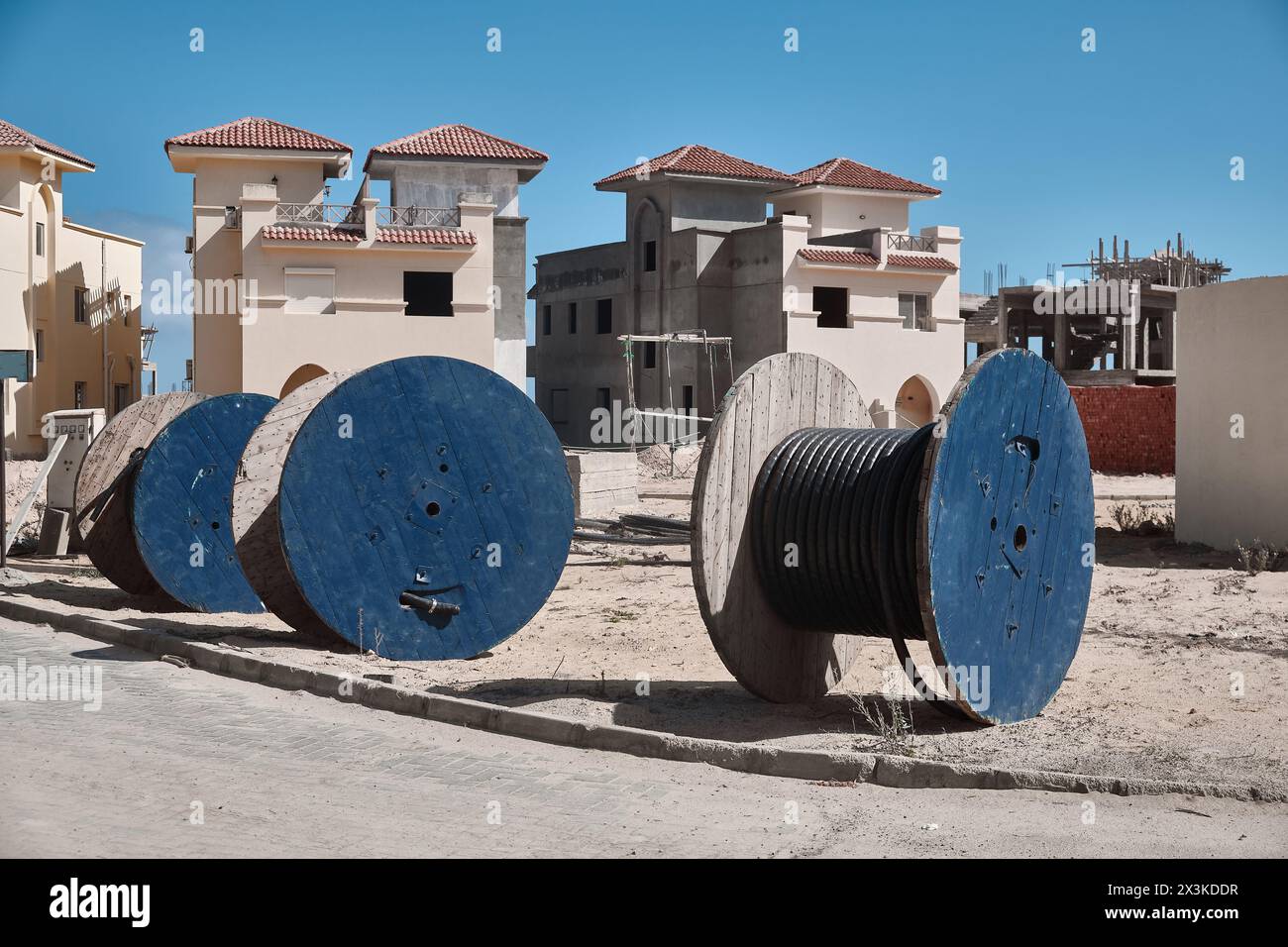 Wooden bobbins with electrical cable Stock Photo - Alamy