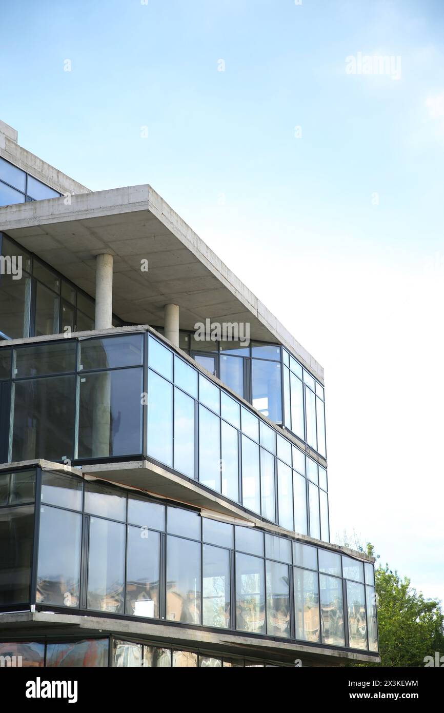 Modern building with big windows against blue sky outdoors Stock Photo ...