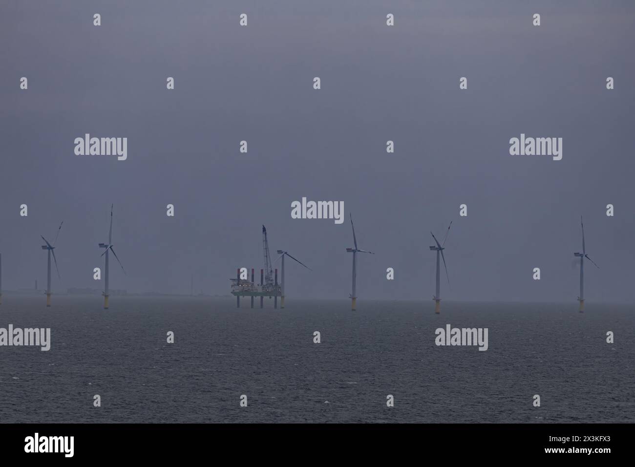 wind mills and an oil rig in the north sea Stock Photo - Alamy