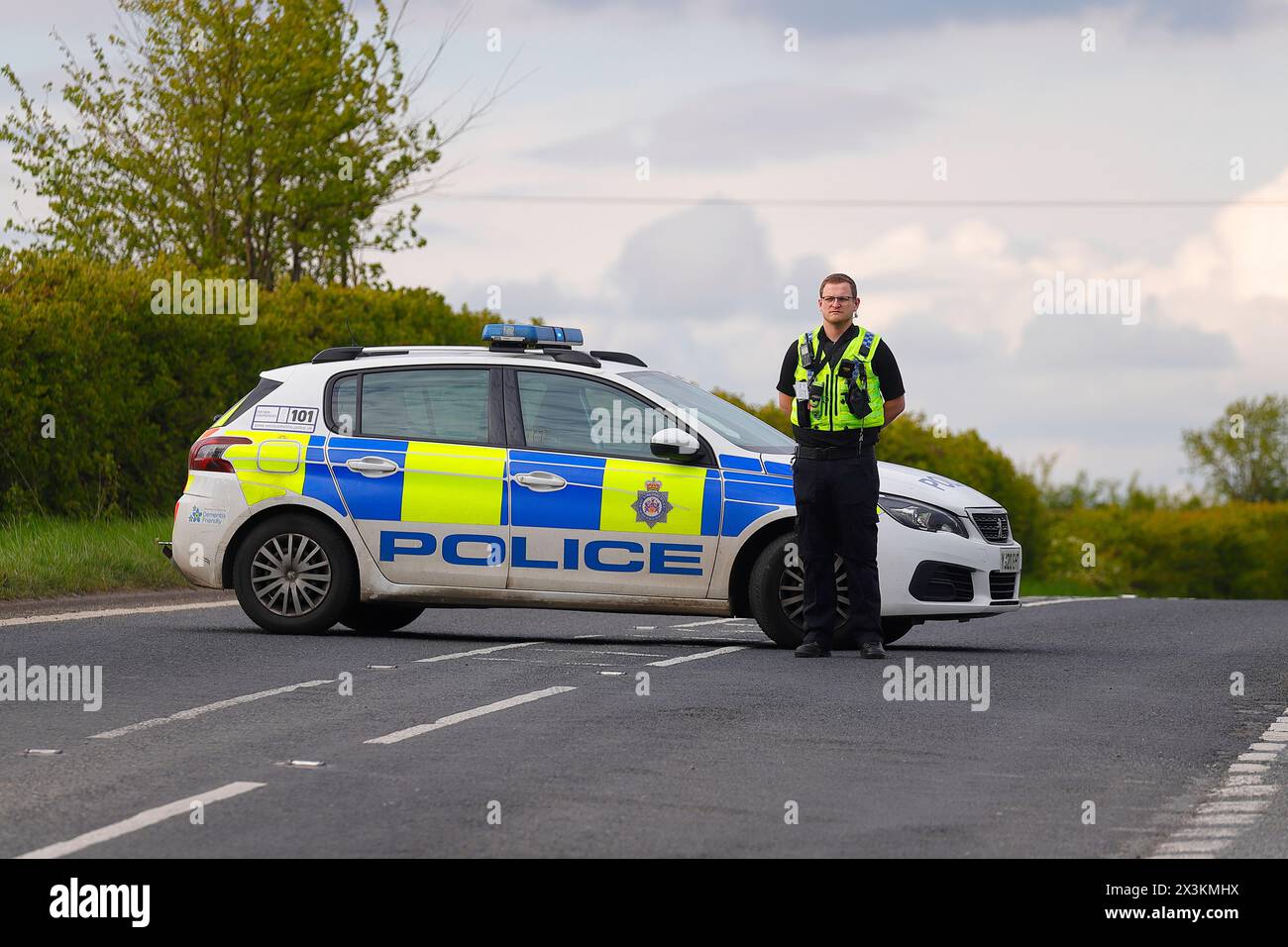 A police officer diverts traffic away from an incident on Wakefield ...