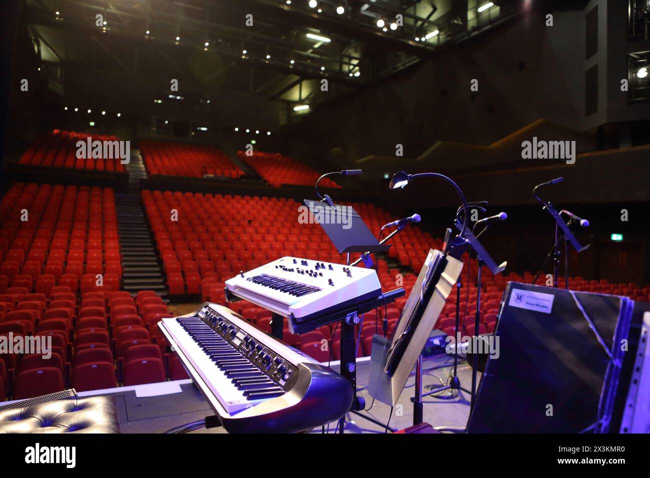 Two keyboards on stage with auditorium seating behind - musician's ...