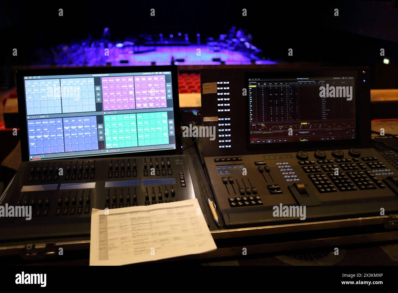 Lighting desk set up for live performance with screens and lighting ...