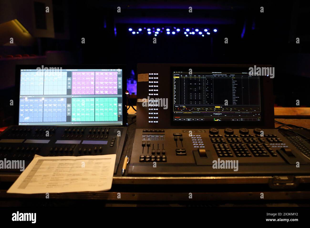 Lighting desk set up for live performance with screens and lighting ...