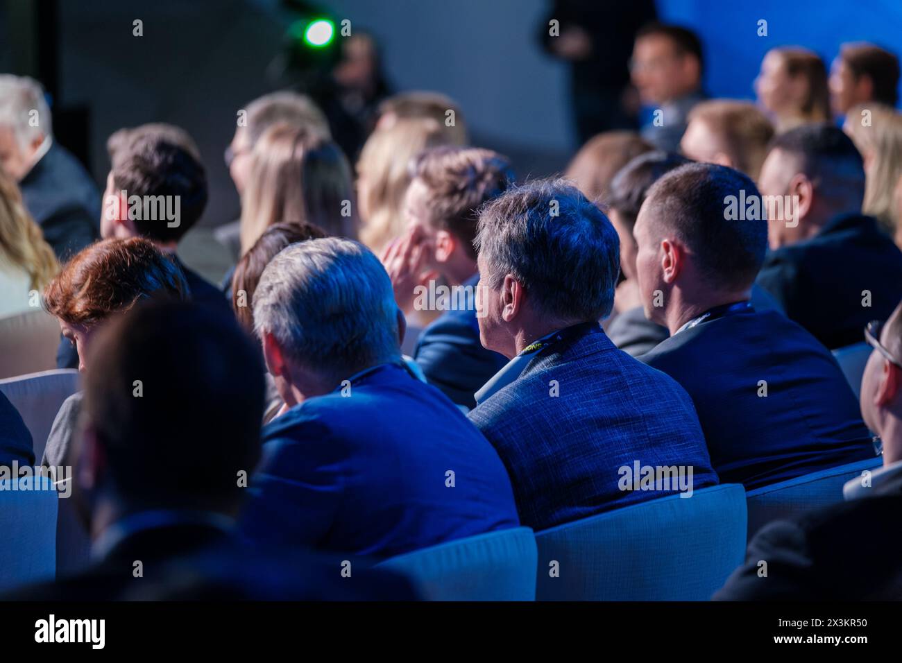 Group of professionals attentively listening during a corporate ...