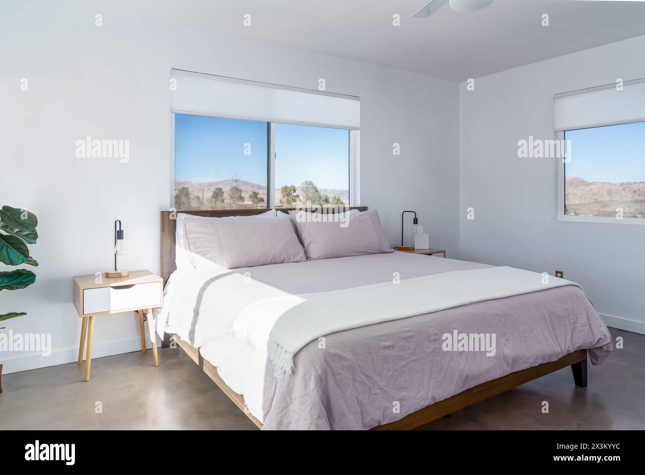 Modern bohemian desert home white bedroom with bed with side table and ...