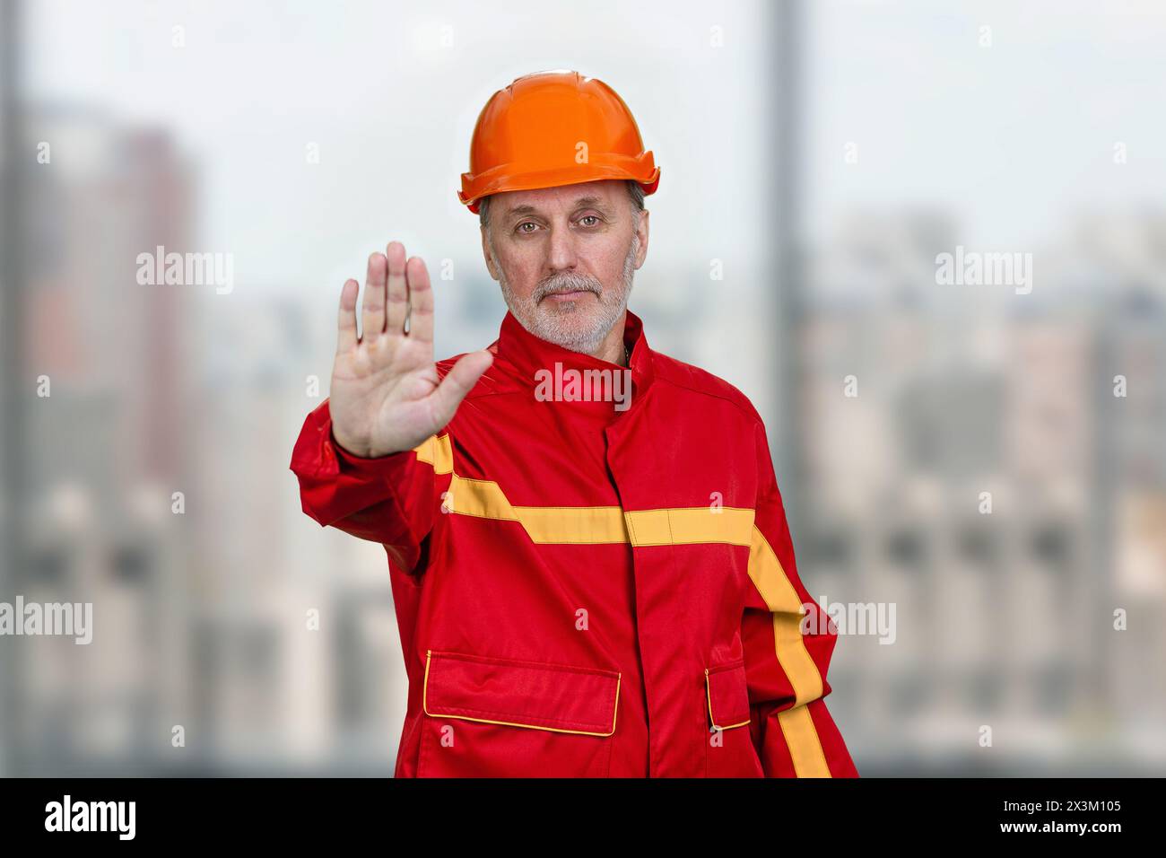 Mature construction worker handyman shows the no reject gesture sign ...
