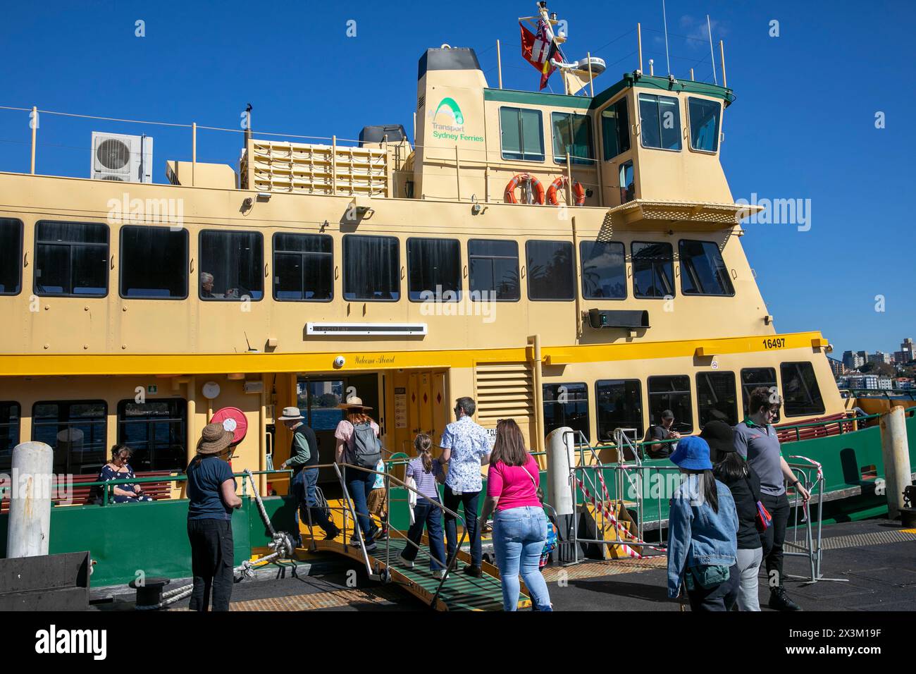 Passengers commuters board a Sydney ferry from Cremorne Point ferry ...
