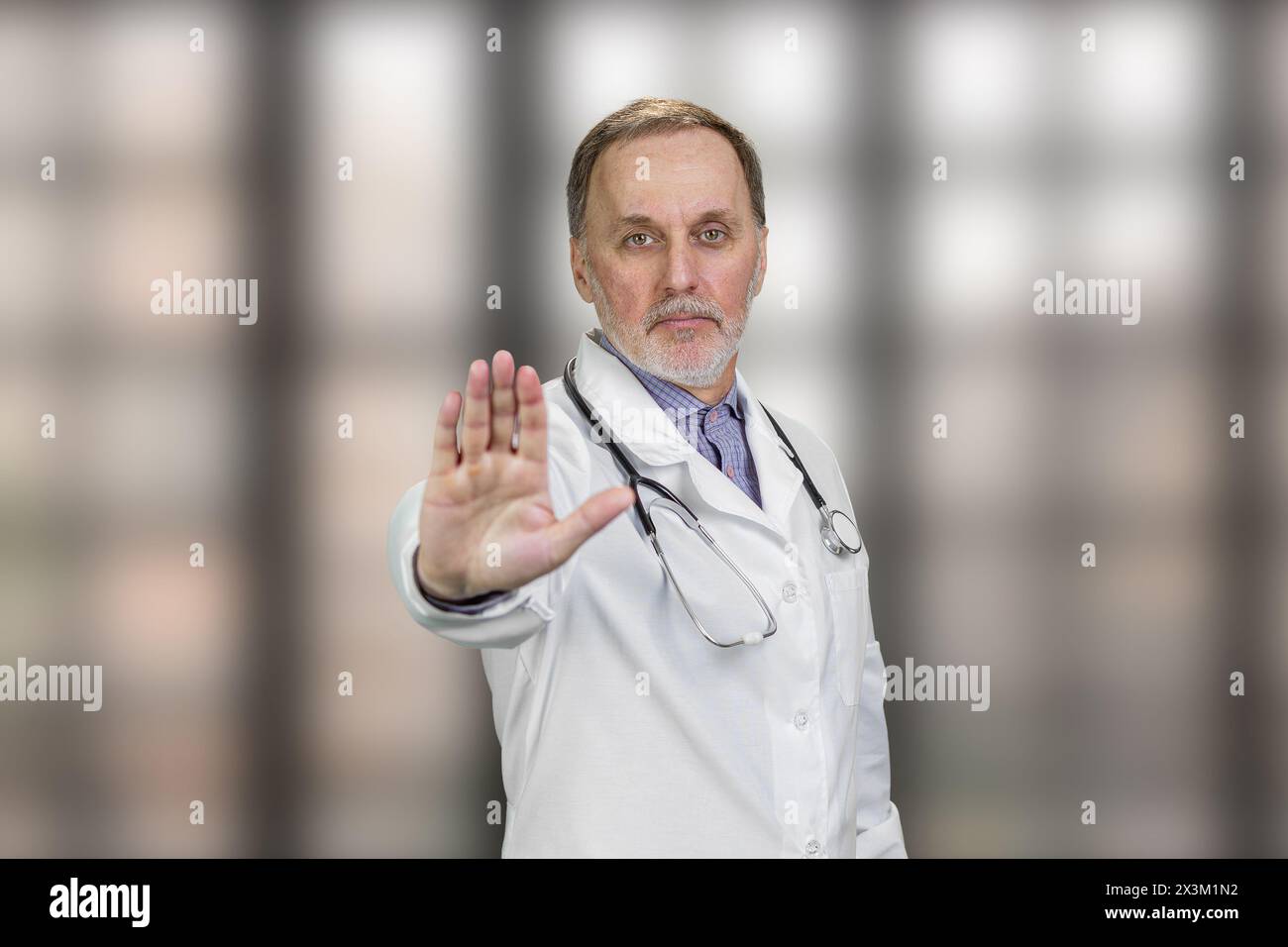 Serious physician doctor shows stop gesture sign. Elder male doctor ...